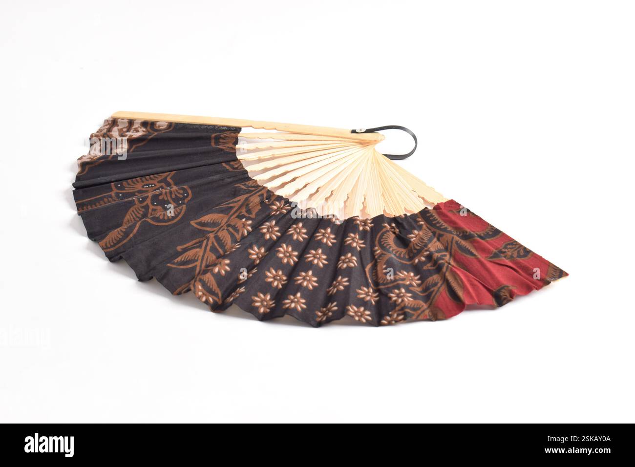 Traditional folding hand fan with batik motif isolated on white ...