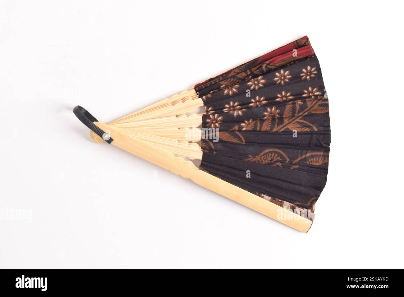 Traditional folding hand fan with batik motif isolated on white ...