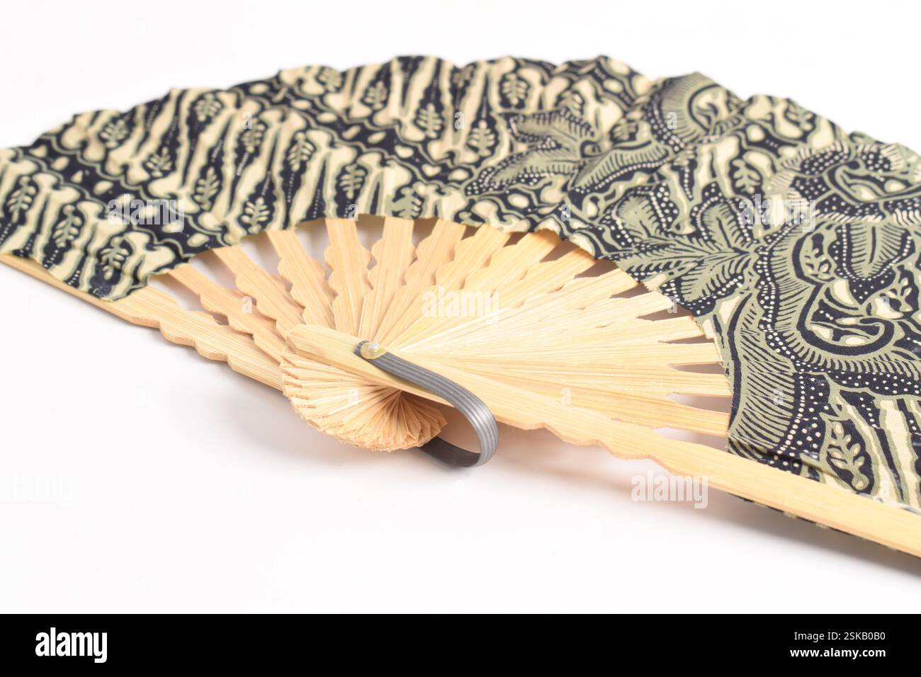 Traditional folding hand fan with batik motif isolated on white ...