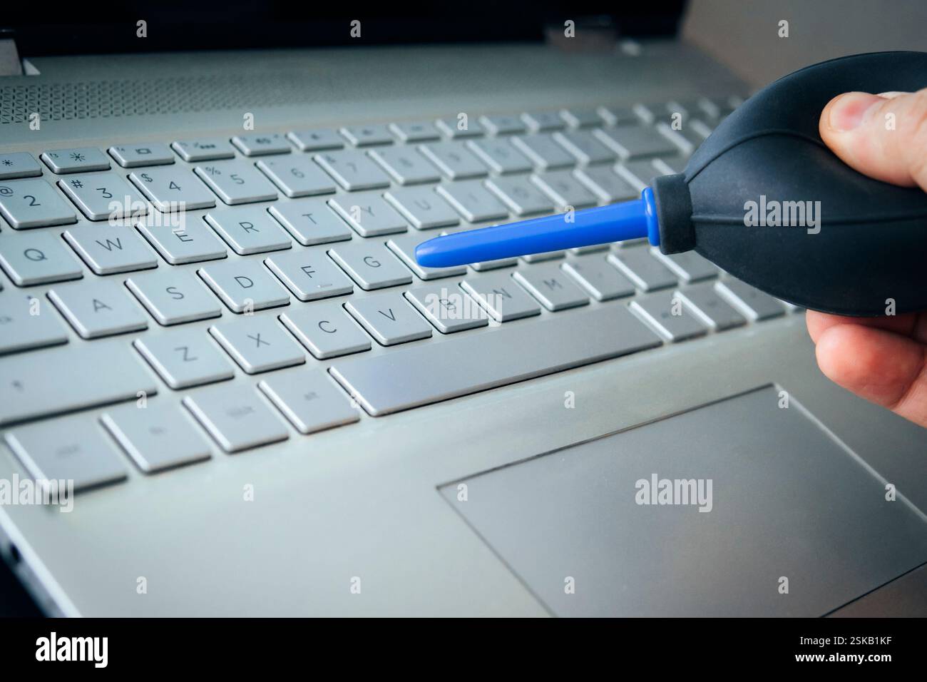 Cleaning computer with blower pump. Blowing debris from under the ...