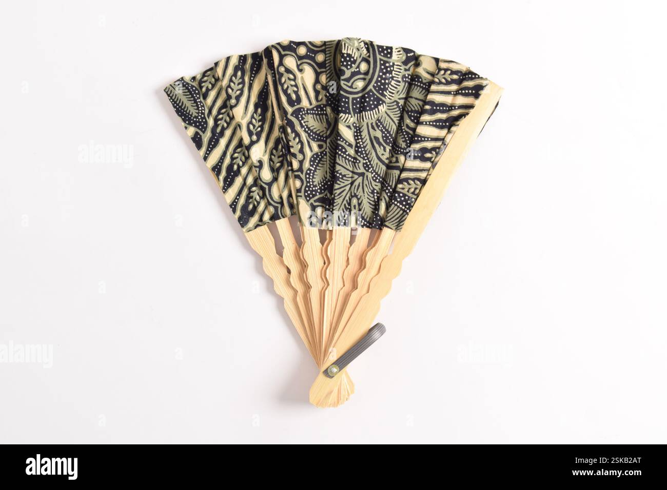 Traditional folding hand fan with batik motif isolated on white ...