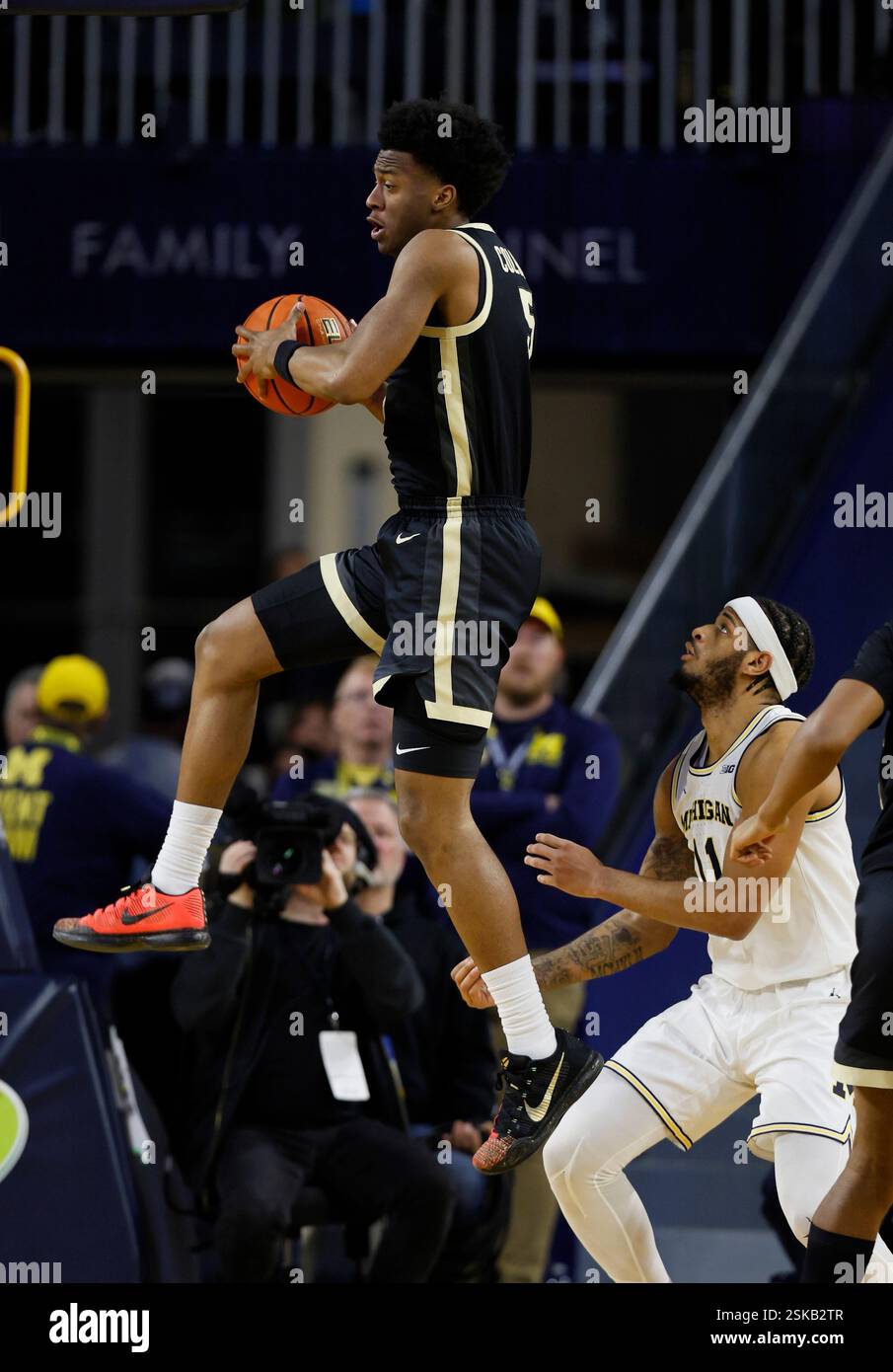 Purdue guard Myles Colvin, left, grabs a rebound in front of Michigan ...