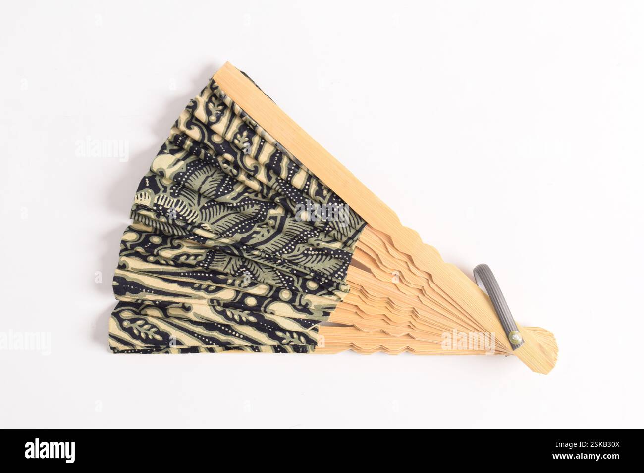 Traditional folding hand fan with batik motif isolated on white ...