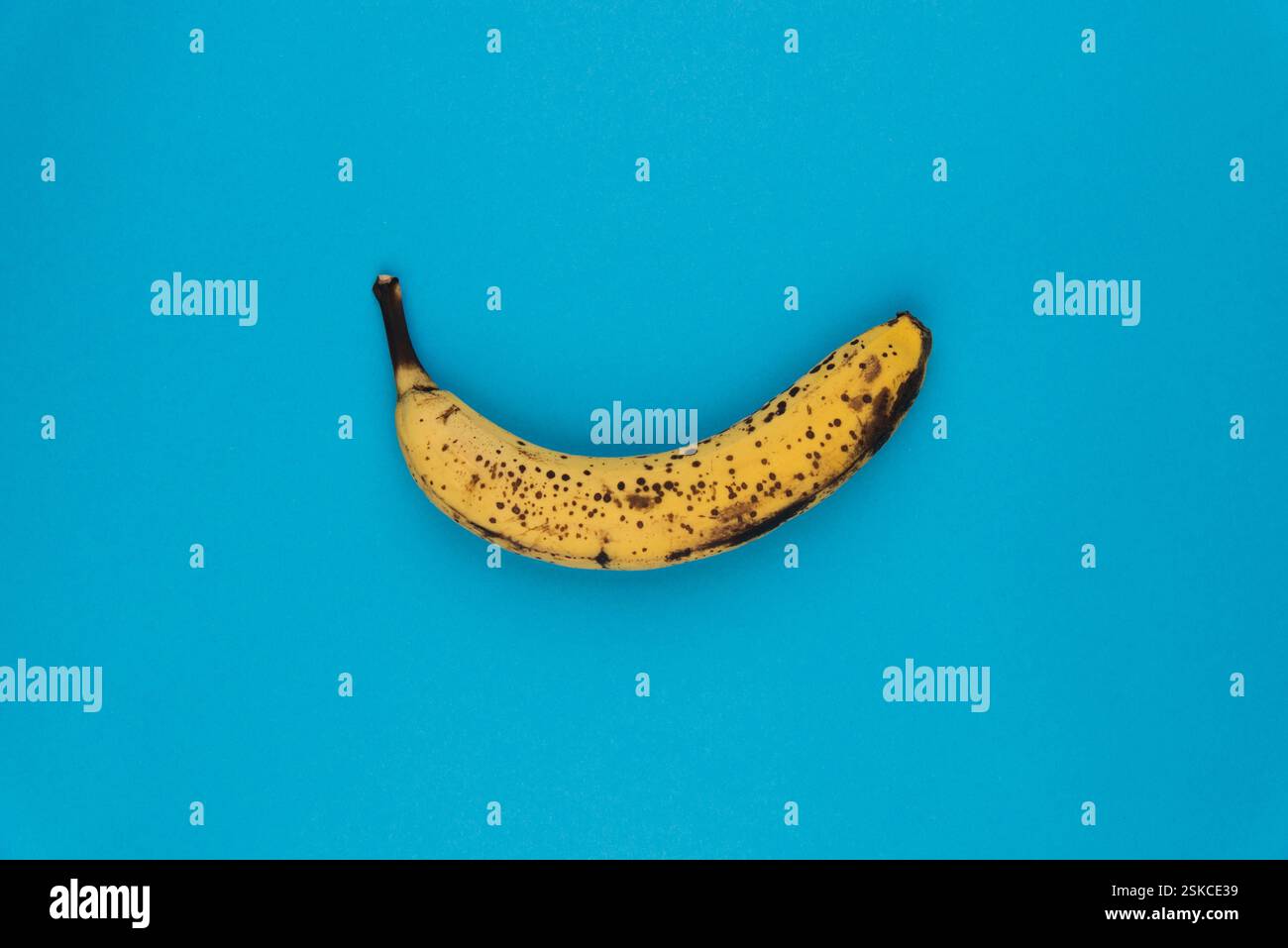 Ripe banana on blue background Stock Photo - Alamy