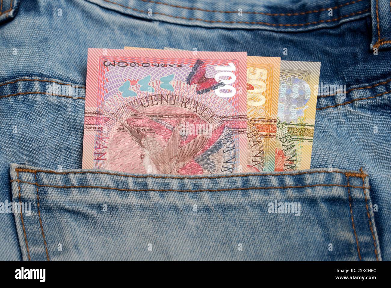 Old Surinamese money - guilder in the pocket of blue jeans Stock Photo ...