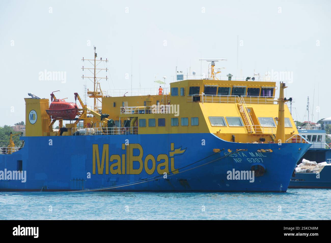 Bahamas: MailBoat ship. Bright blue hull with yellow superstructure ...