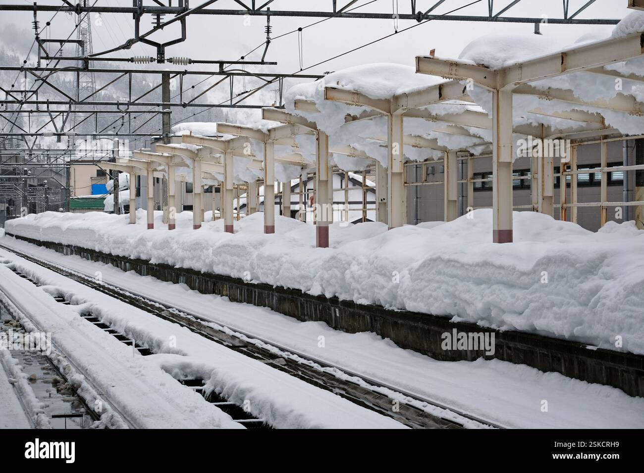 Snow-covered train platform at a train station in Gunma Prefecture ...