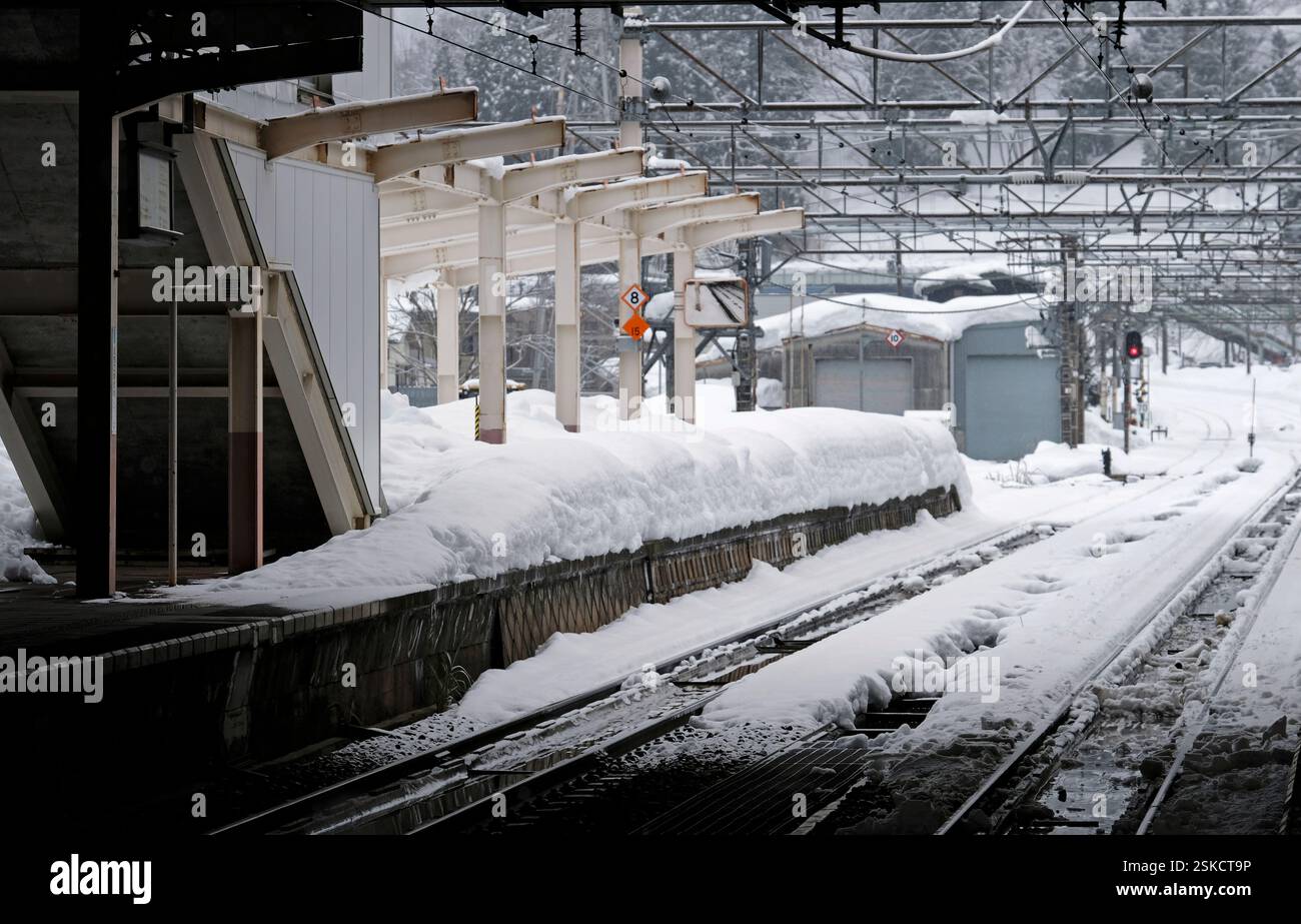 Snow-covered train platform at a train station in Gunma Prefecture ...