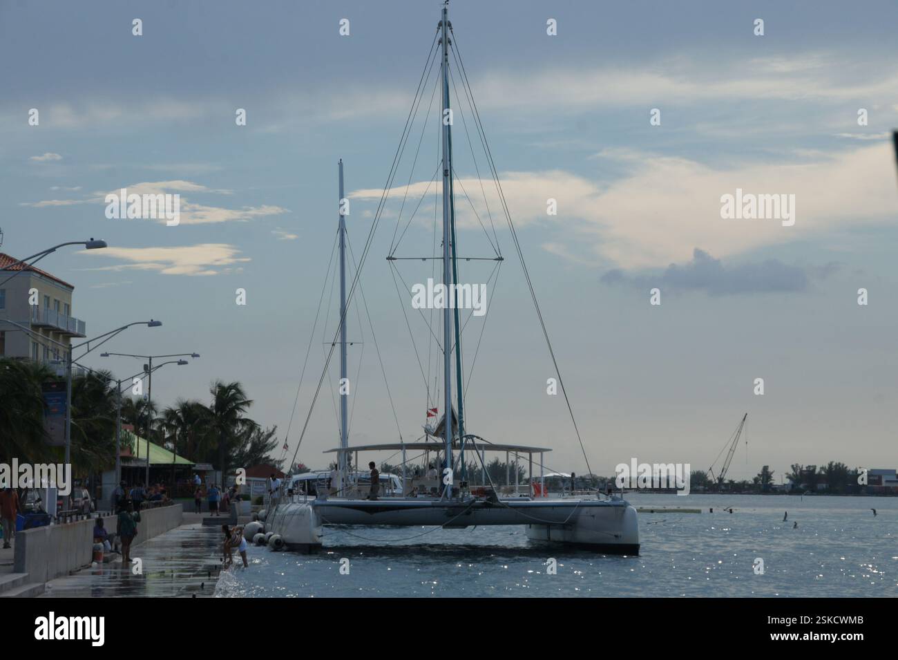Serene ocean scene shows sailboat hi-res stock photography and images ...