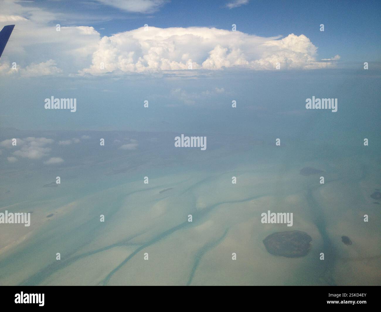 Aerial photo of turquoise shallow water with dark green patches ...