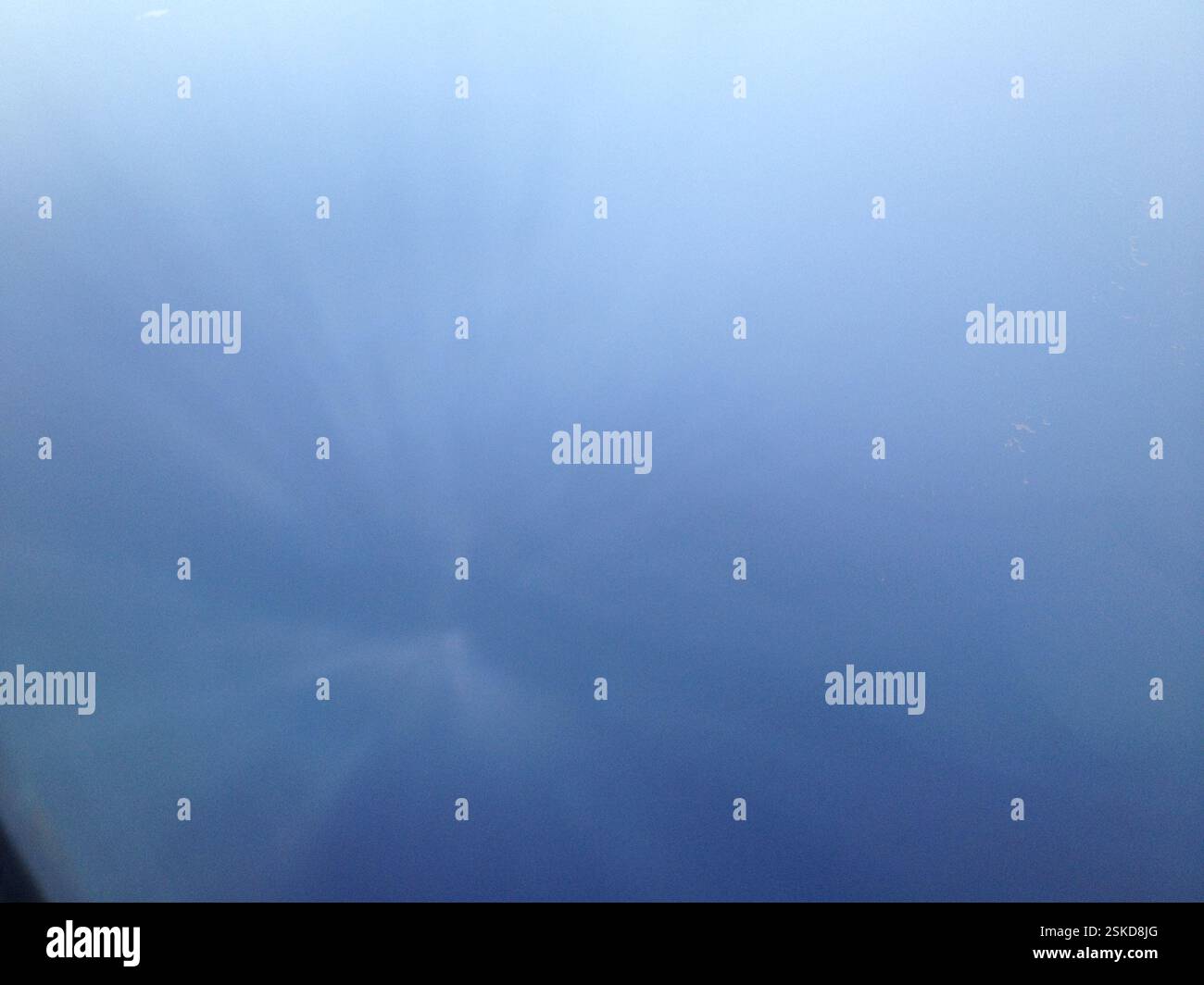 Aerial photo of the Bahamas. Hazy blue sky with faint vertical streaks ...