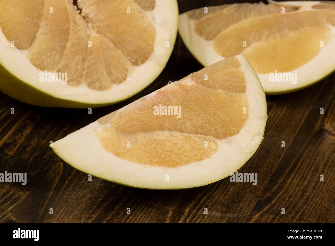 pomelo with lots of pulp cut into pieces, huge juicy citrus closeup ...