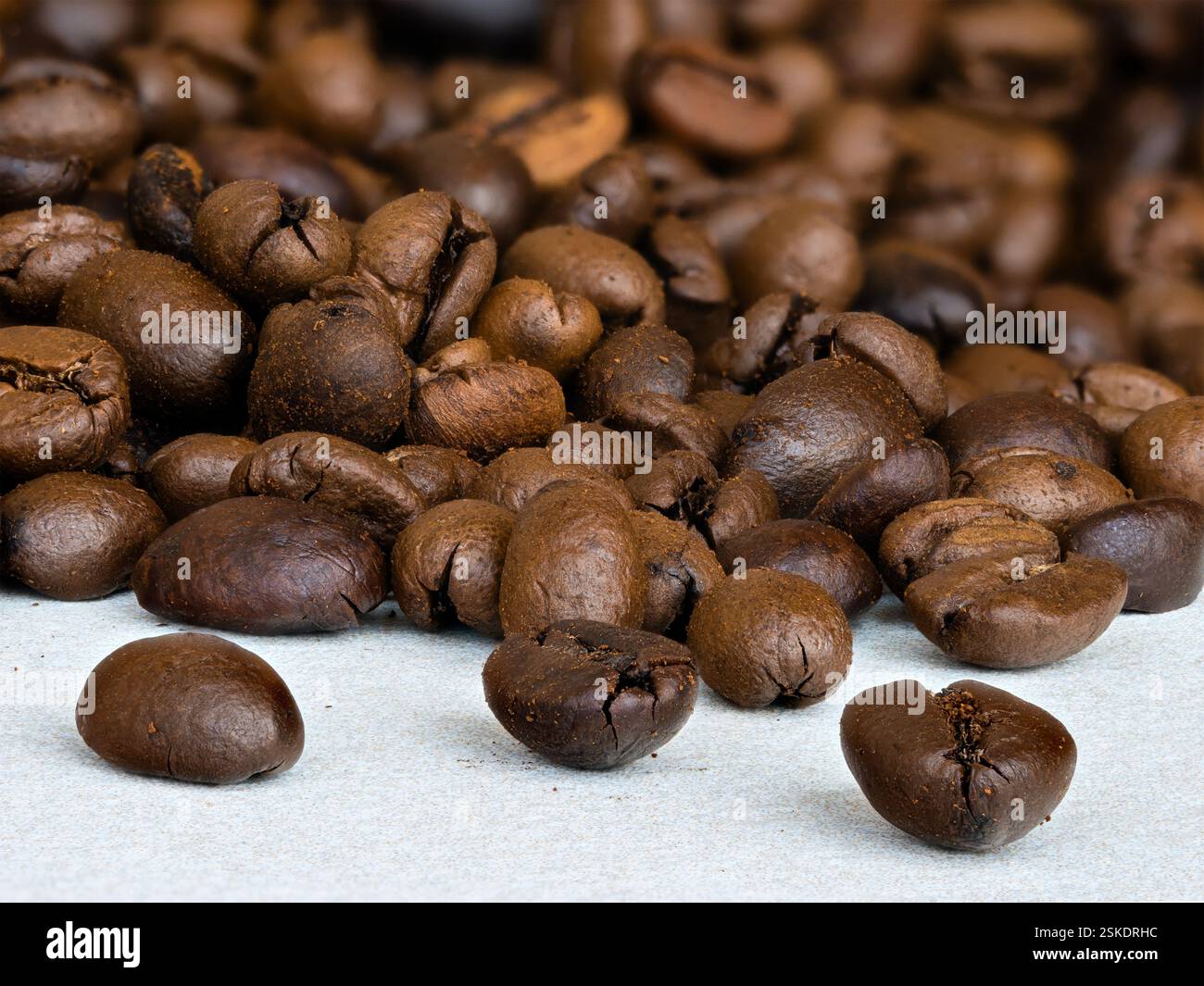 Macro photo of spilled coffee beans on a light background Stock Photo ...