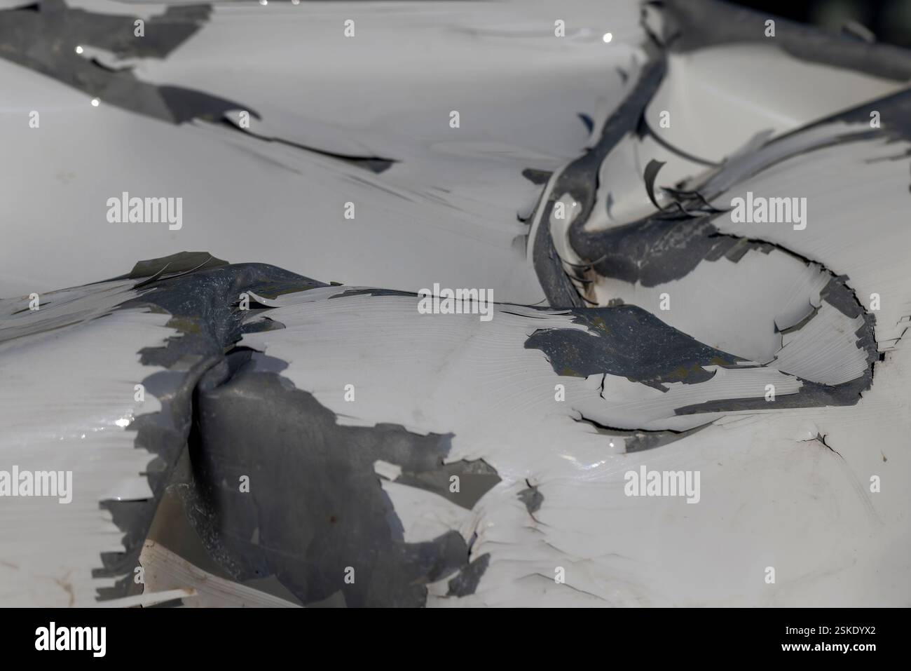 the damaged car is white after the accident, the paint is removed from ...