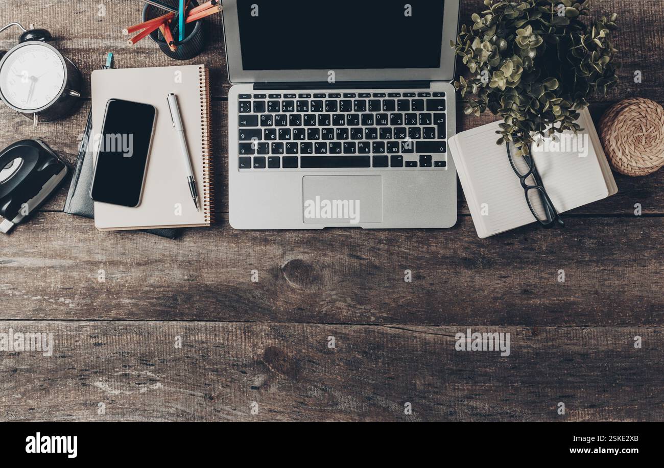 Workspace setup with laptop, stationery, and personal items for ...