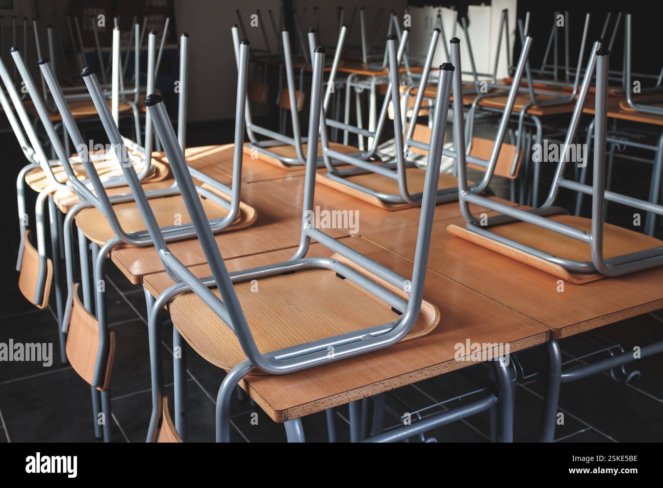 Classroom with Tables and Chairs Stacked Together Stock Photo - Alamy