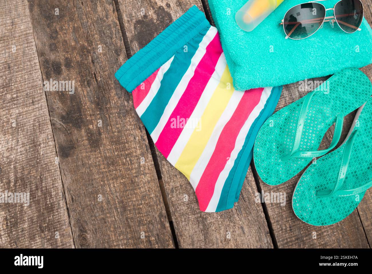 Summer beach essentials laid out on wooden surface for a fun day in the ...