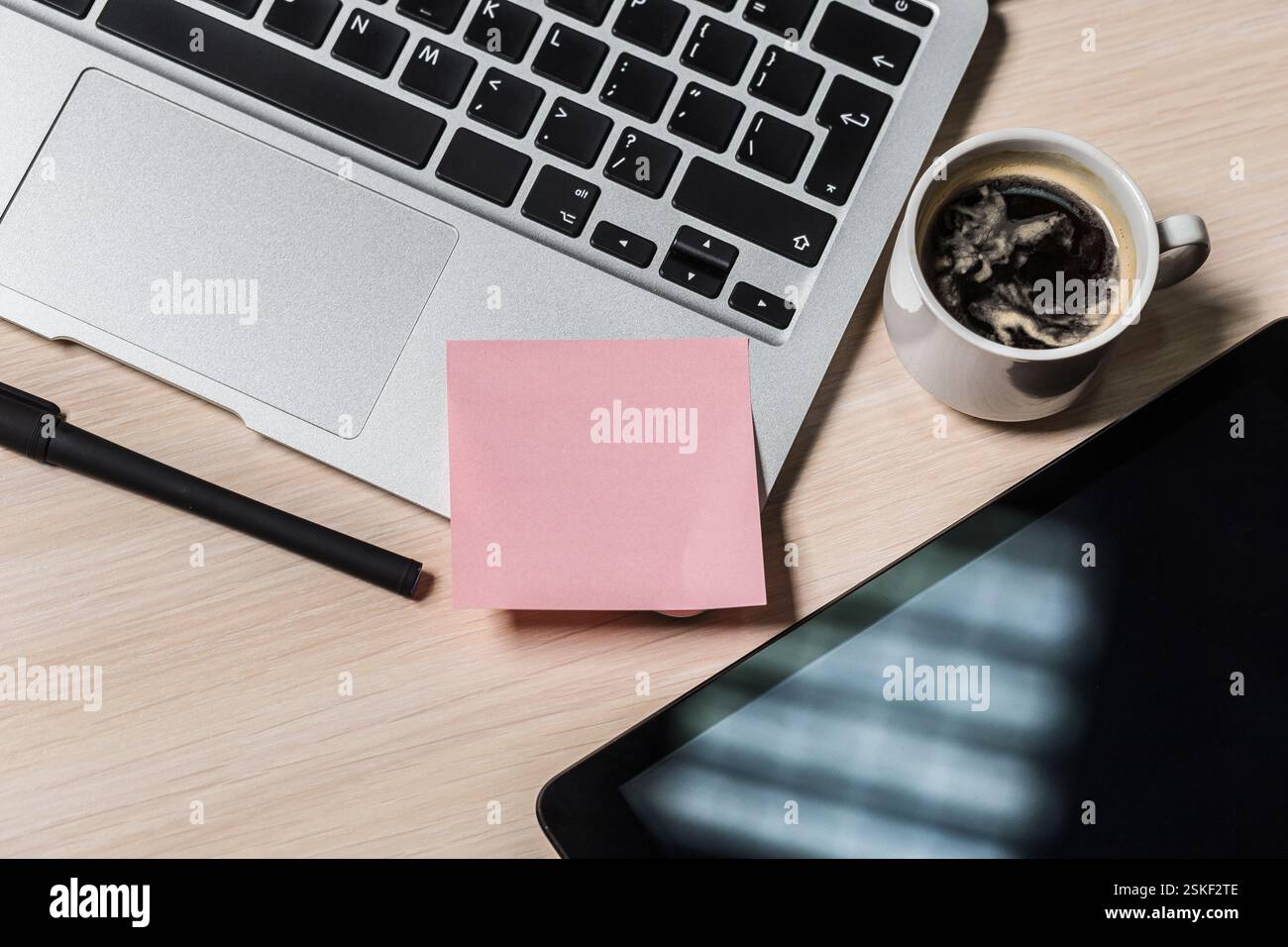Workspace setup with laptop, coffee, and tablet during a productive ...