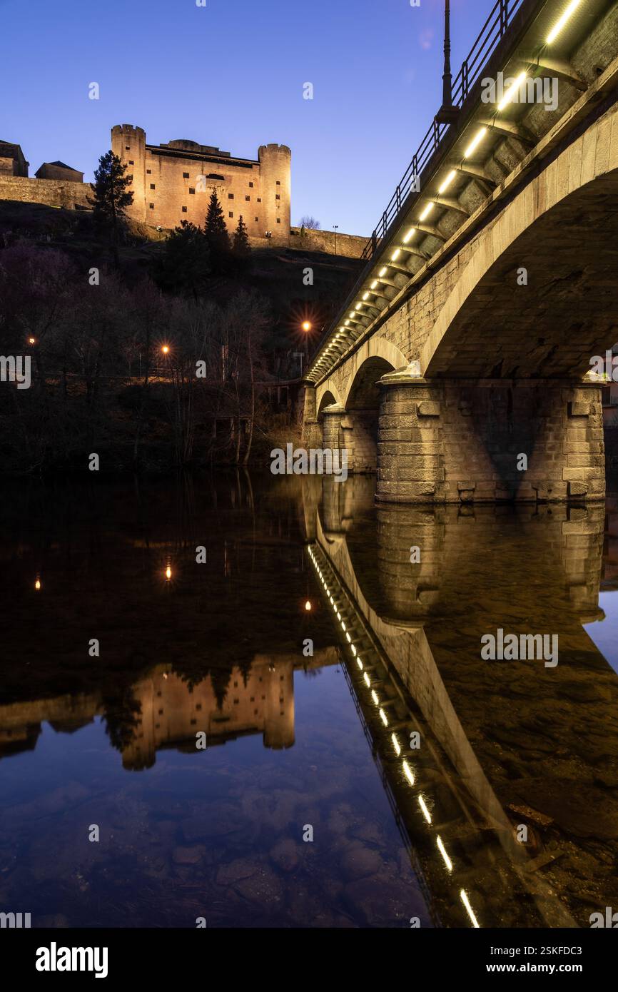 Castle and bridge illuminated at night of the medieval village of ...