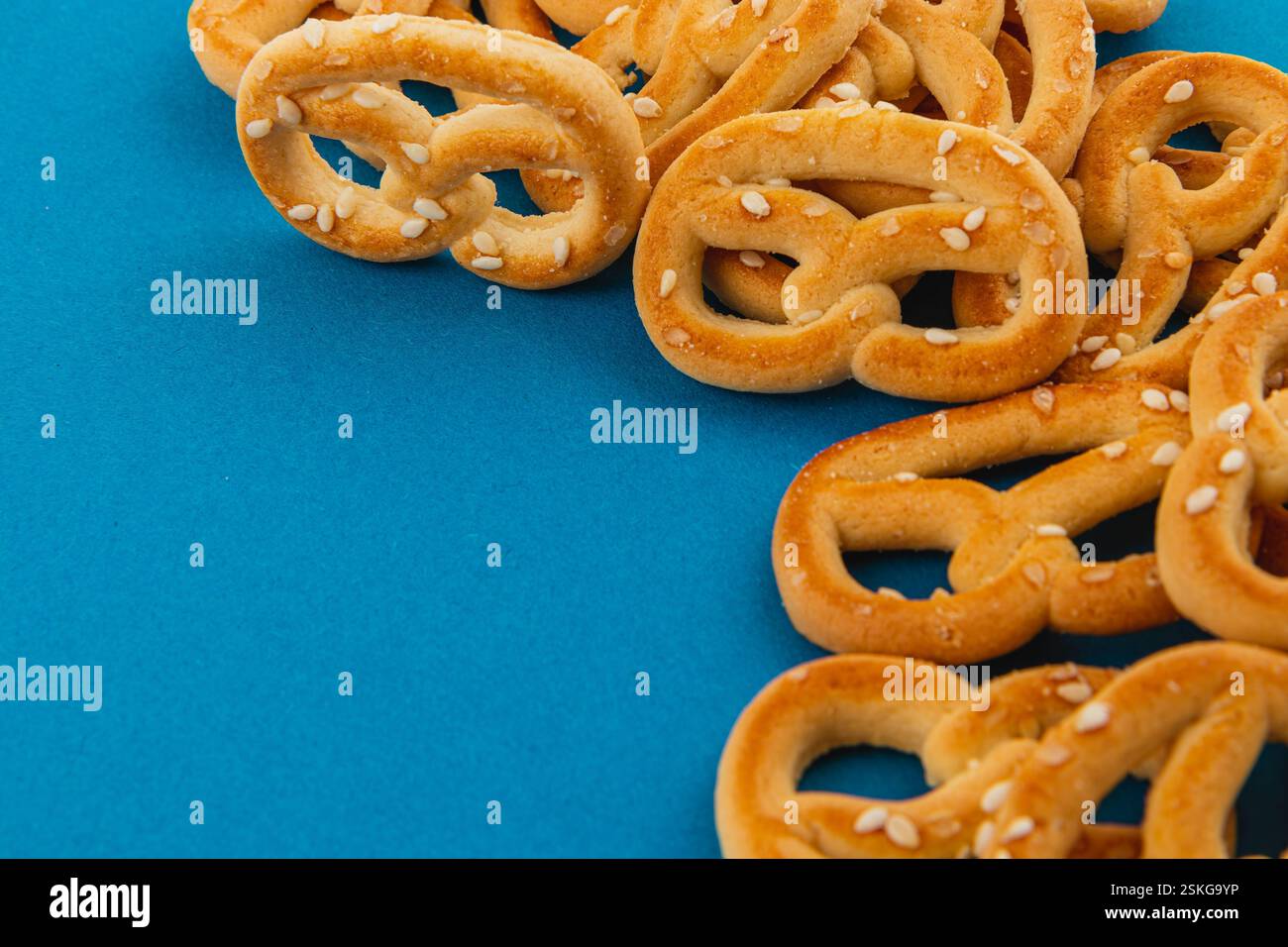 Soft pretzels with a golden brown crust are artfully scattered across a ...