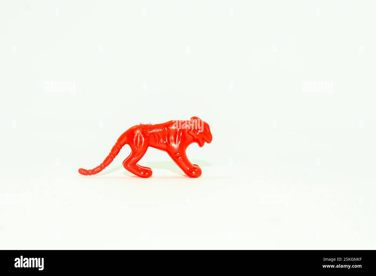 Here is a red color tiger toy. The toy is made of plastic, which ...