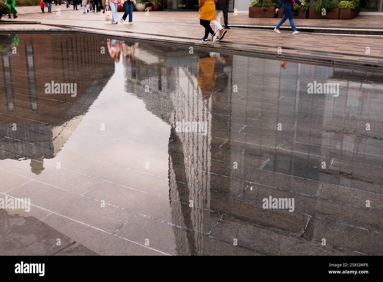 Urban buildings reflecting in water feature Stock Photo - Alamy