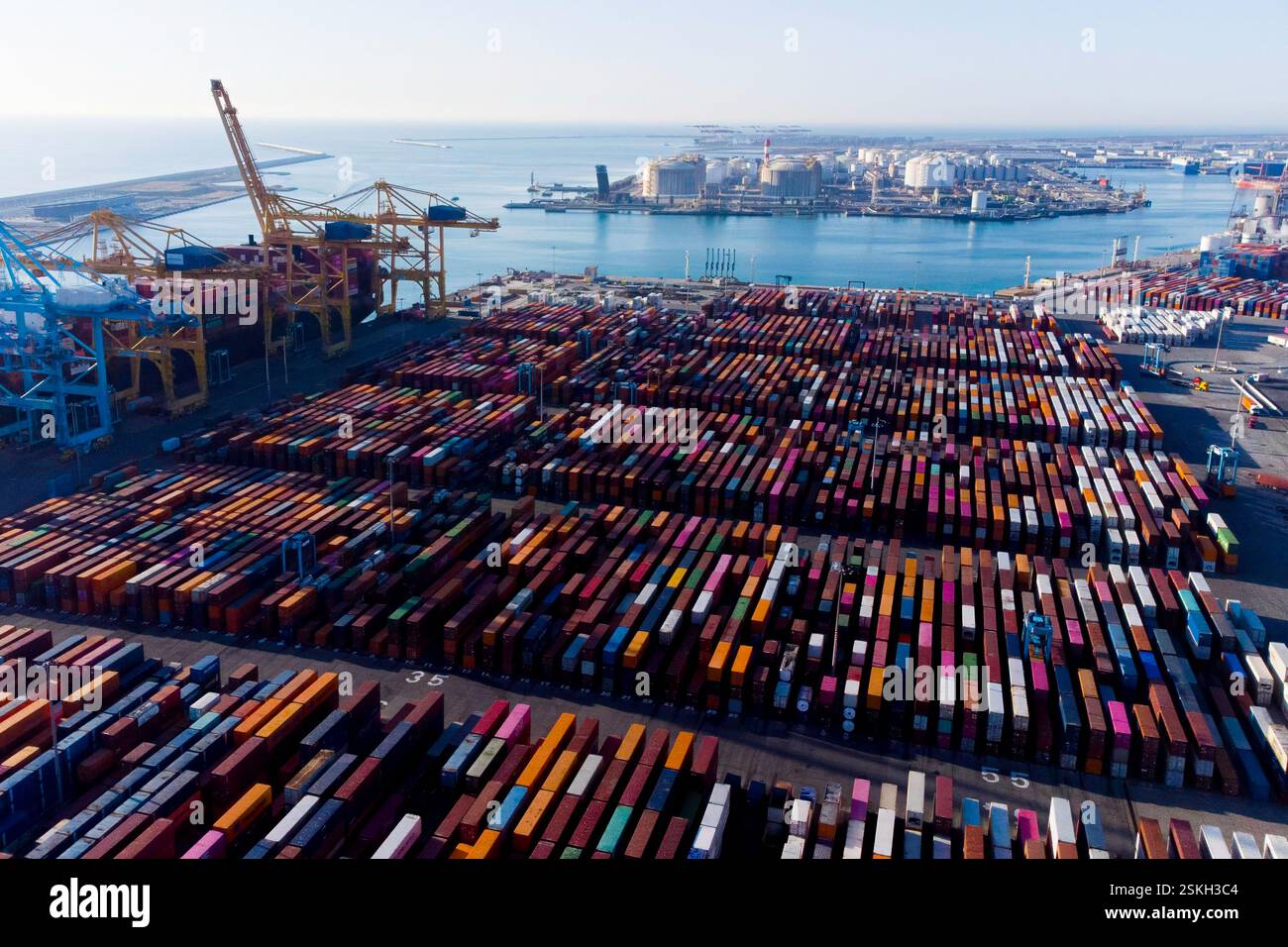 Aerial view of shipping containers and cargo ships in the sea port of ...