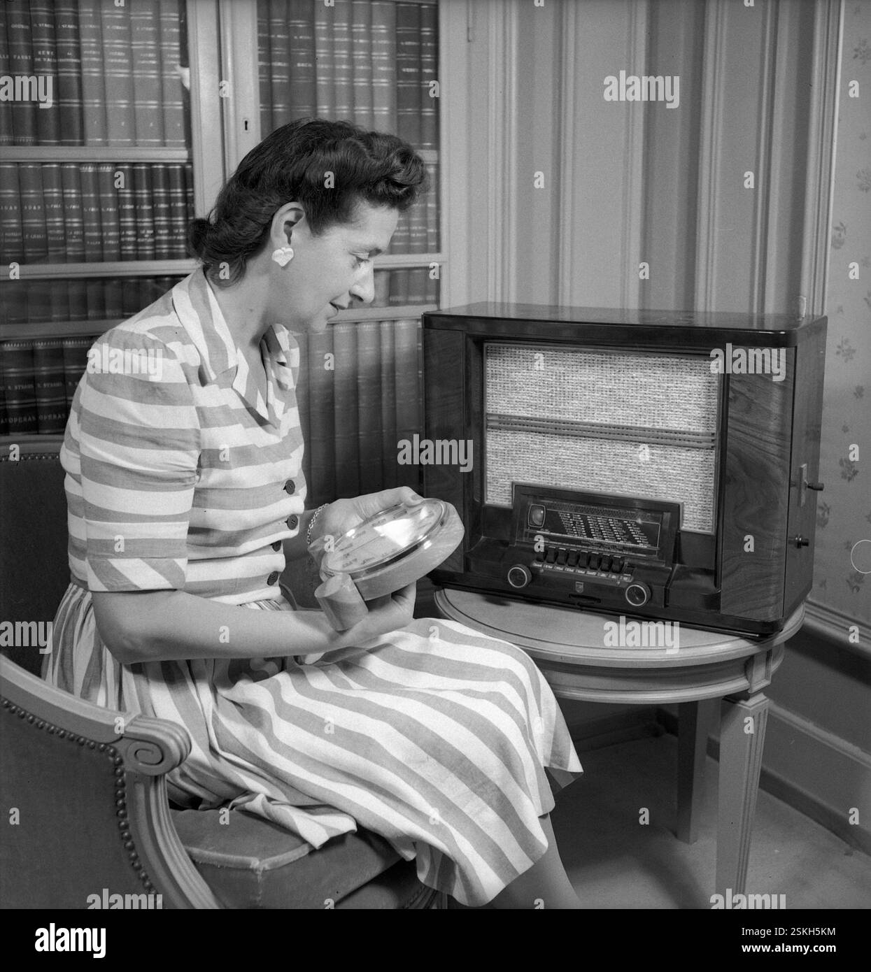 Frau stellt die Uhrzeit nach der Zeitansage des Radios ein 1940#Woman ...