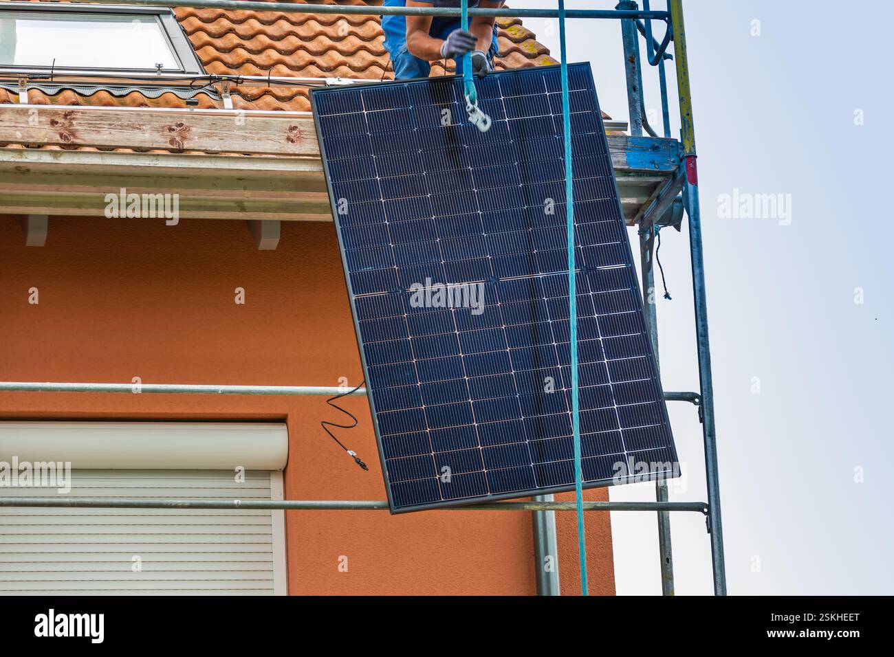Installing solar panels on a roof. Solar panels on roof. Workers ...
