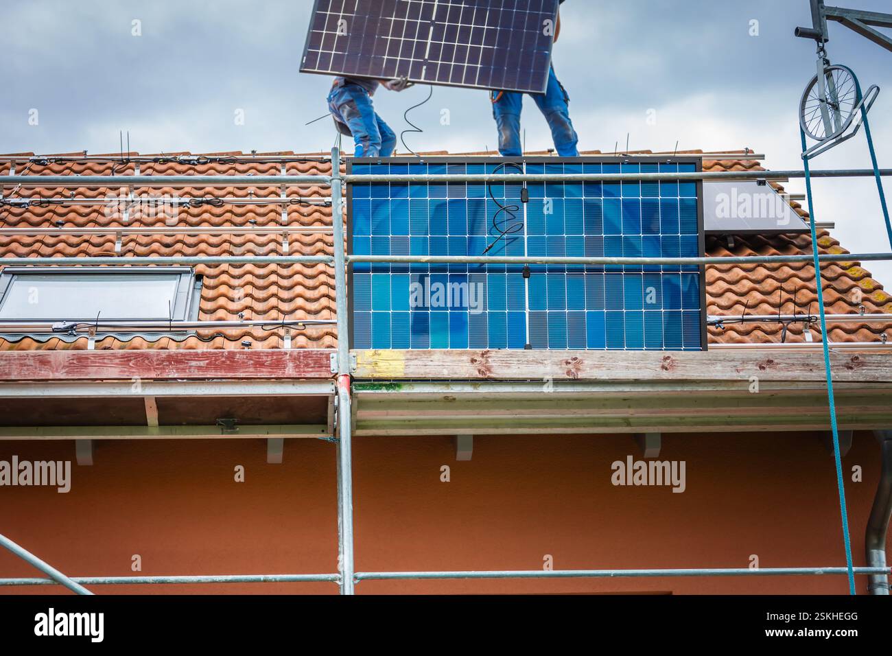 Installing solar panels on a roof. Solar panels on roof. Workers ...