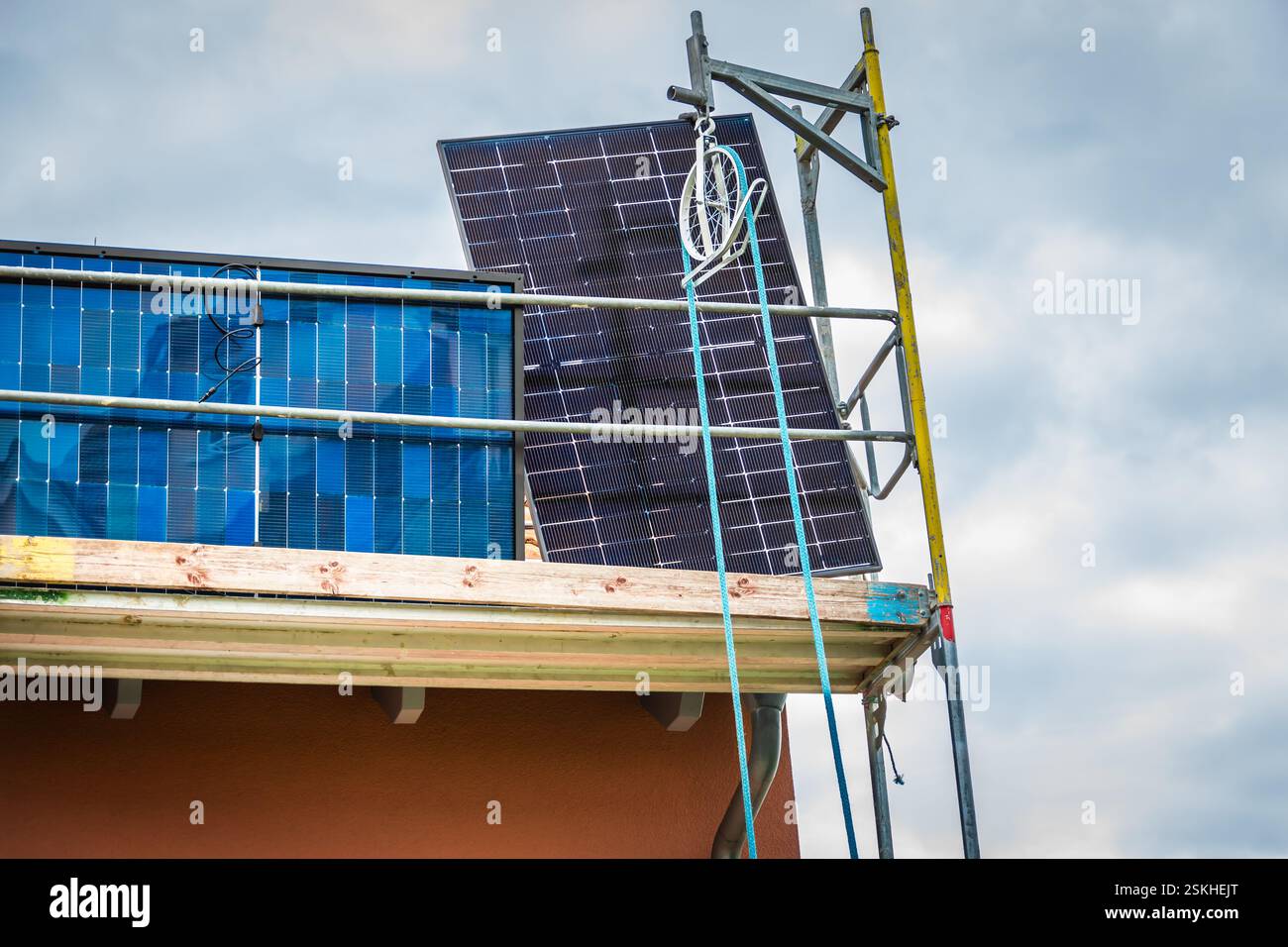 Installing solar panels on a roof. Solar panels on roof. Workers ...