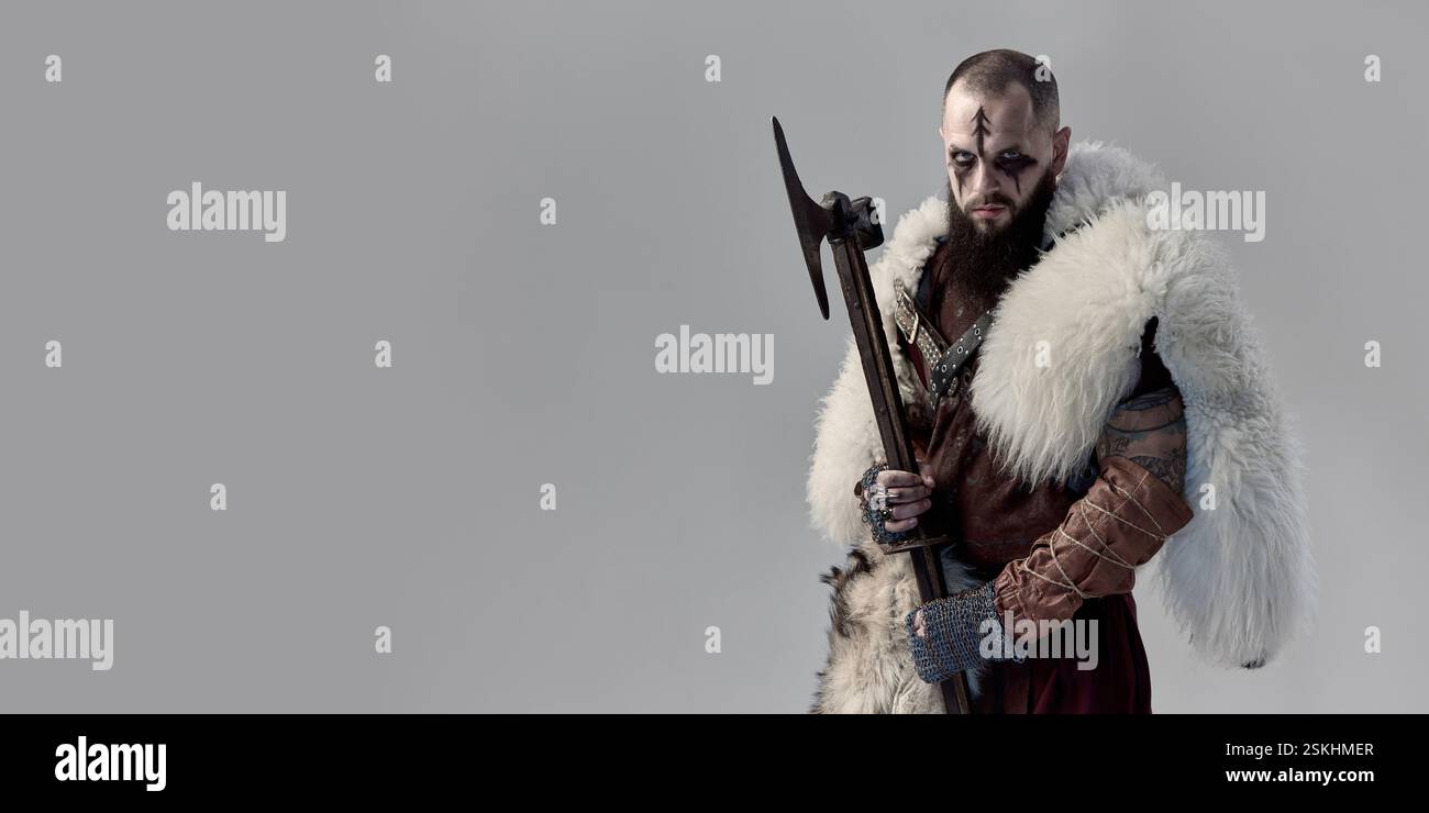 Portrait of serious man as medieval Viking with furious gaze and dark ...