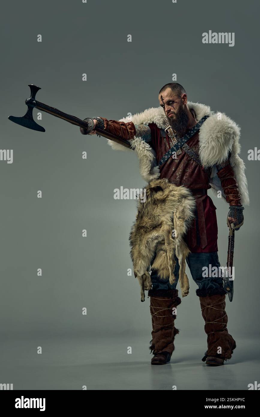 Full-length portrait of man dressed as medieval warrior, Viking in full ...