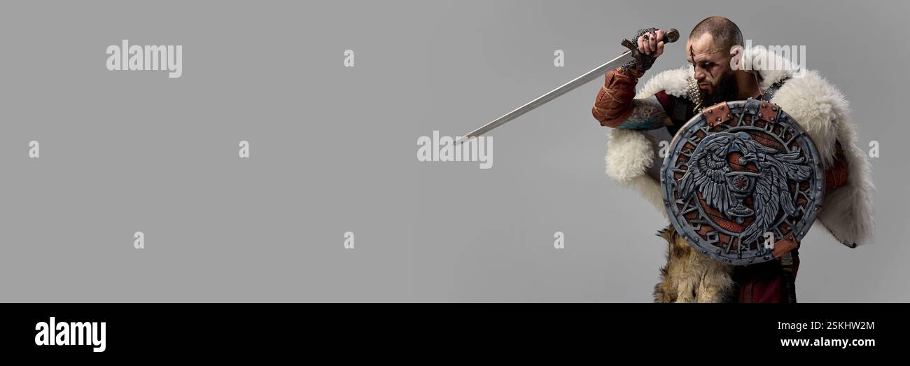 Moment of defense. Medieval warrior, Viking dressed in fur cloak and ...