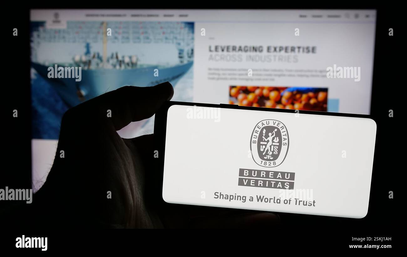 In this photo illustration, a person is holding a mobile phone with the ...
