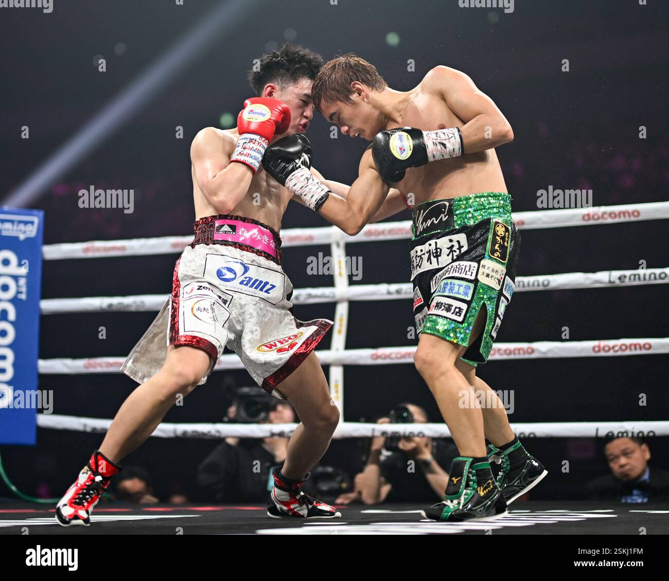 Tokyo, Japan. 24th Jan, 2025. Challenger Yuni Takada (black gloves) hits champion Goki Kobayashi ...