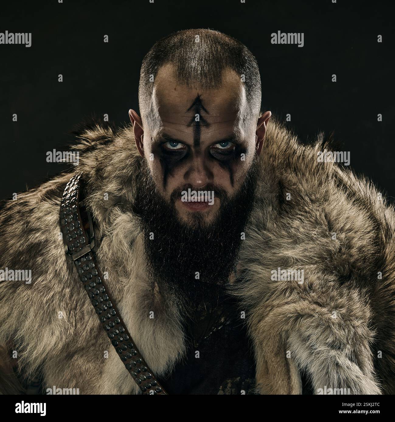 Close-up portrait of Viking warrior with war paint, piercing blue eyes ...