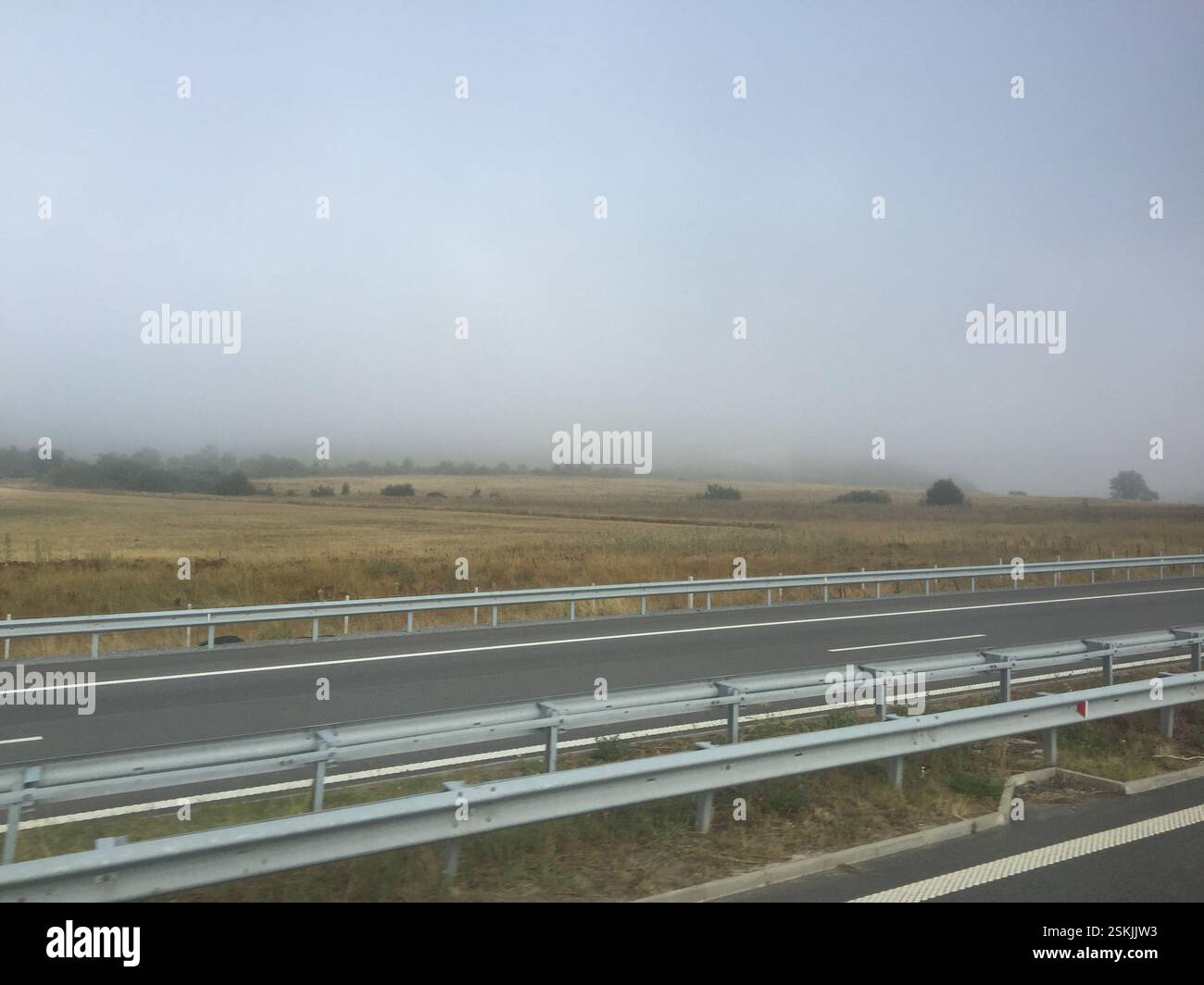 Highway. Flat landscape with fog. Long road with white lines. Feeling ...