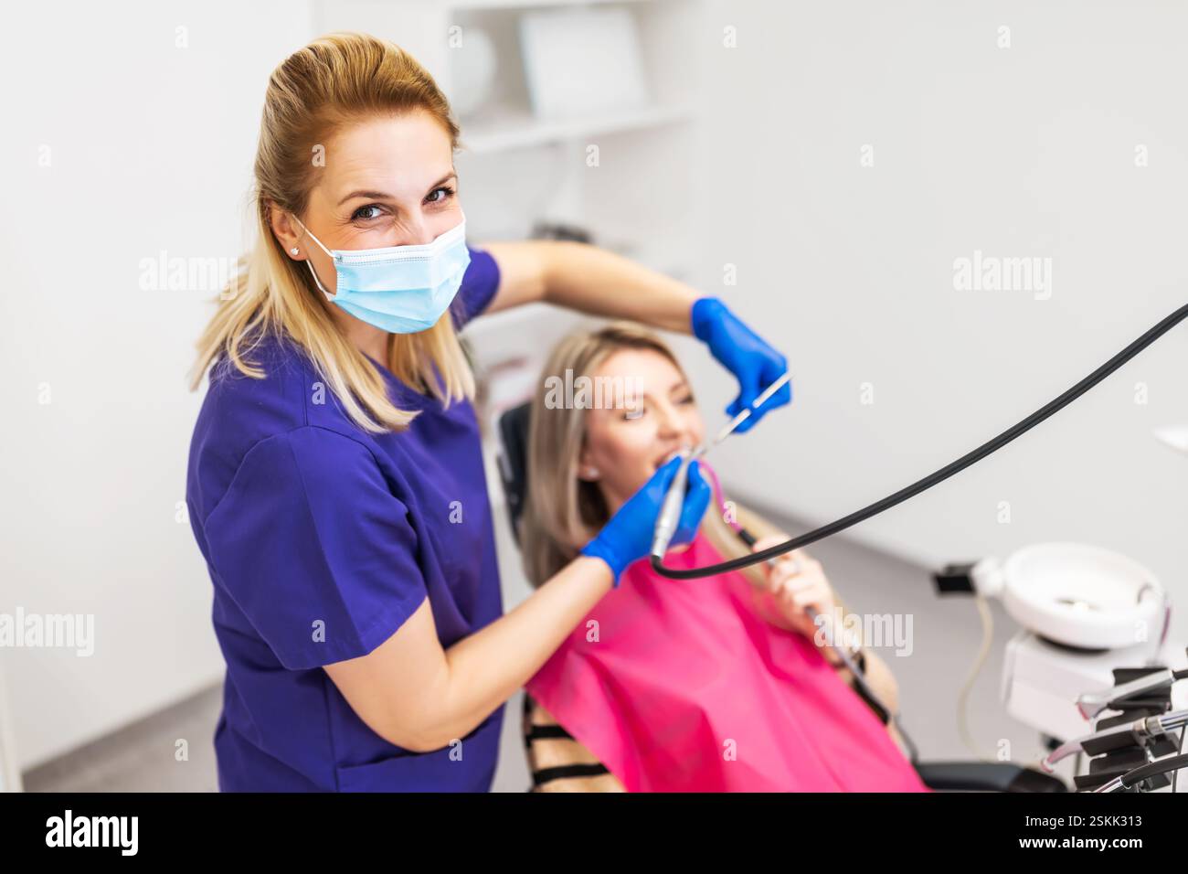Dentist drilling the teeth of the patient. Young woman having her teeth ...