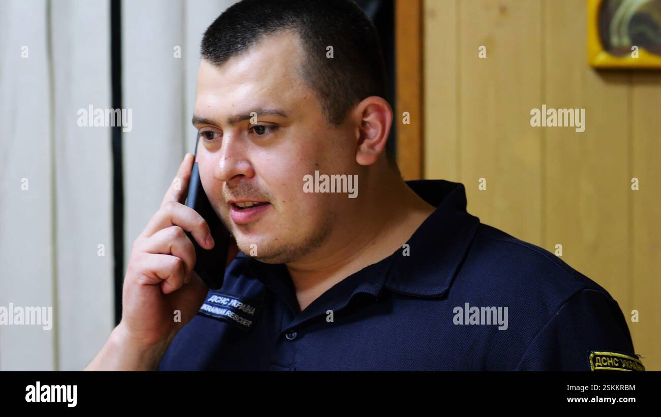 Male firefighter chief have serious telephone conversation with his ...