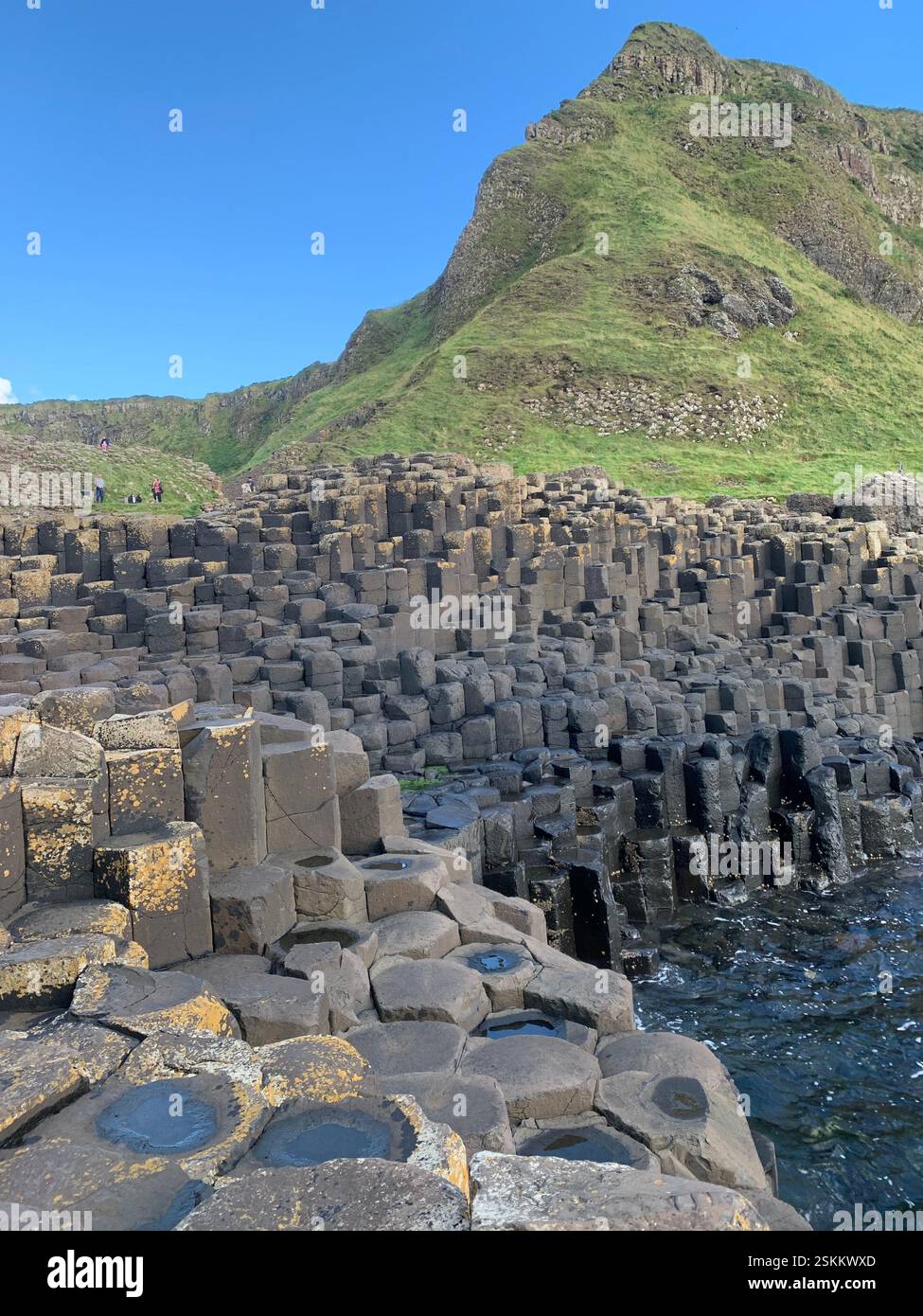 hiking along the Giants Causeway cliffs Stock Photo - Alamy