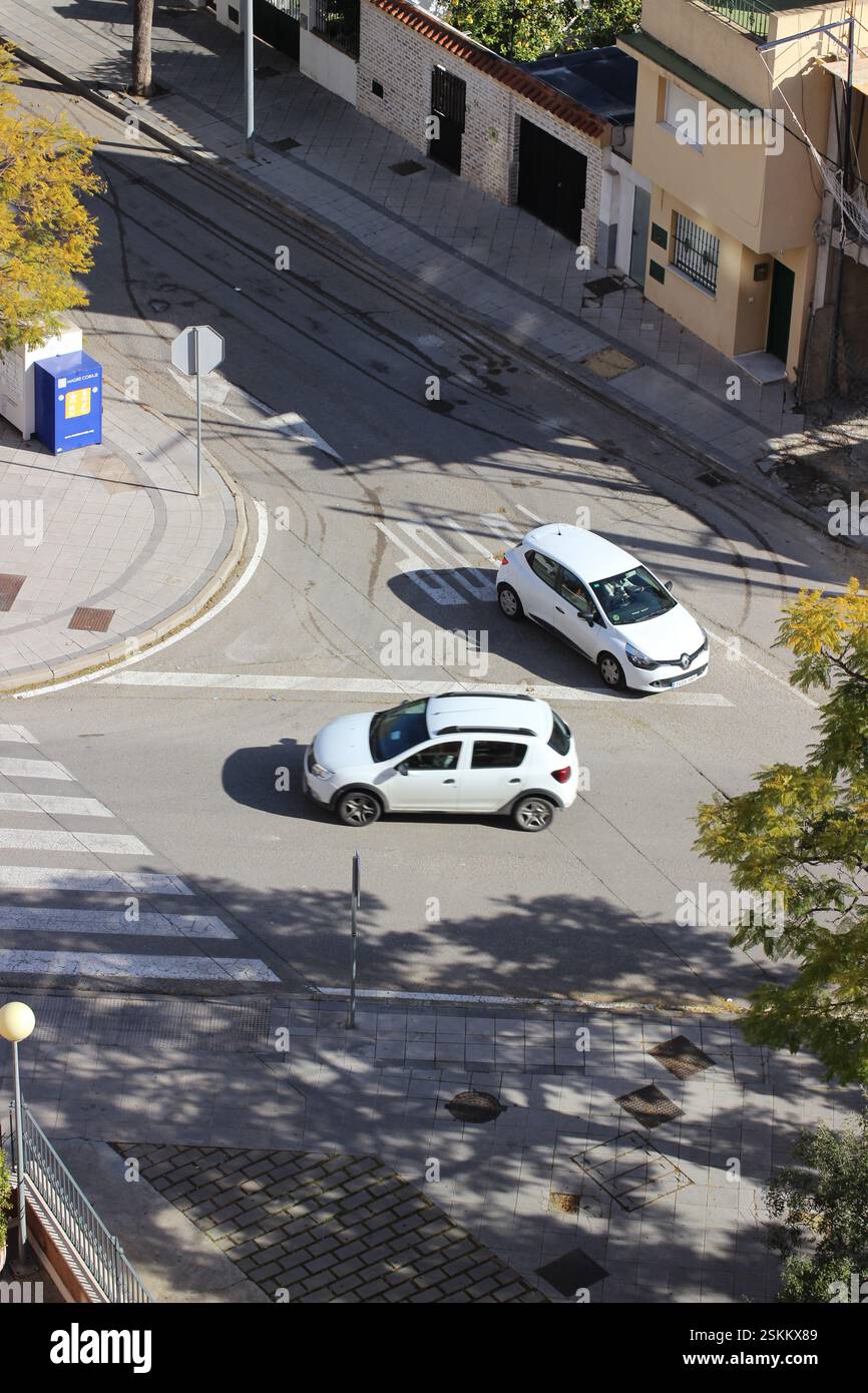 Image of a grey city road intersection, with cars, signs and zebra ...
