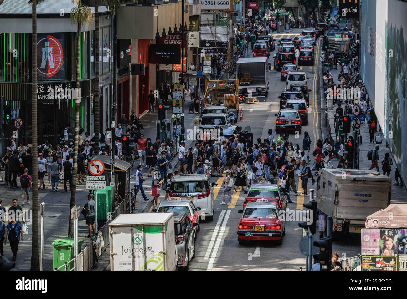 People walk under surveillance camera in Hong Kong. Hong Kong police ...