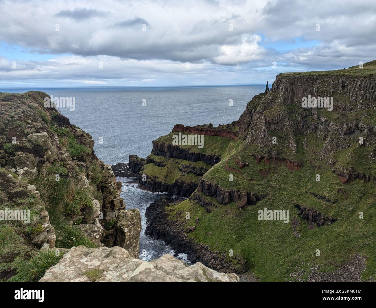 hiking along the Giants Causeway cliffs Stock Photo - Alamy