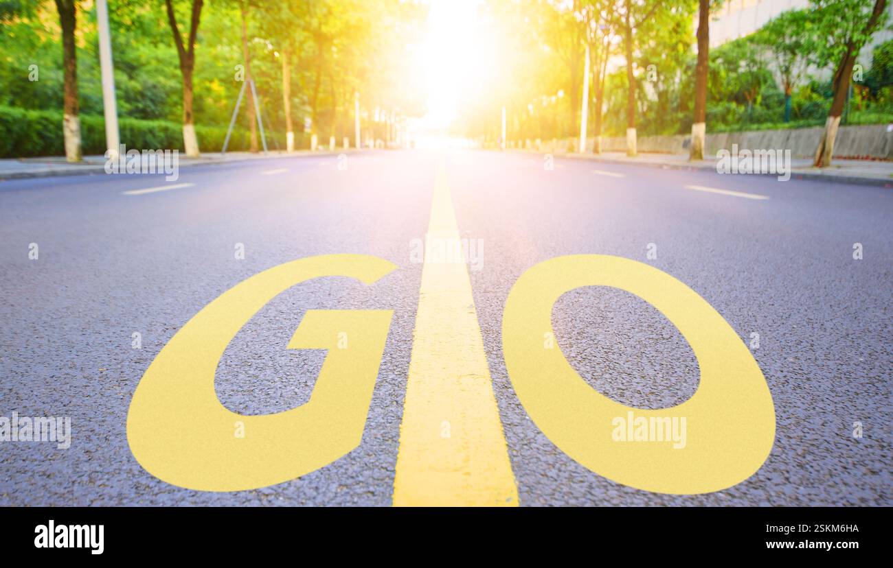 A straight road leads to the sunny distance, with GO written in the ...