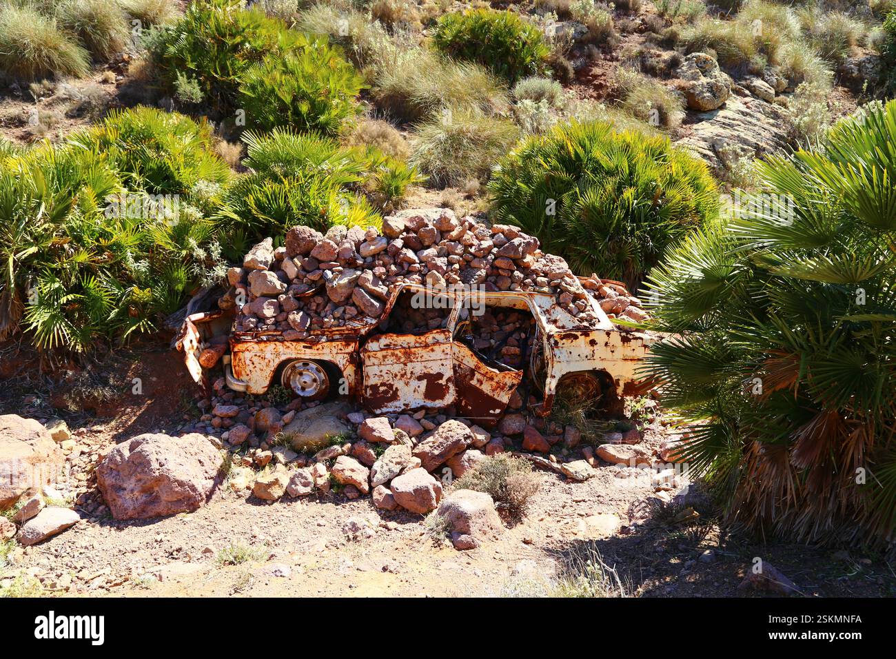 Abandoned Rusty Car Covered in Rocks in a Natural Landscape. Caldera ...