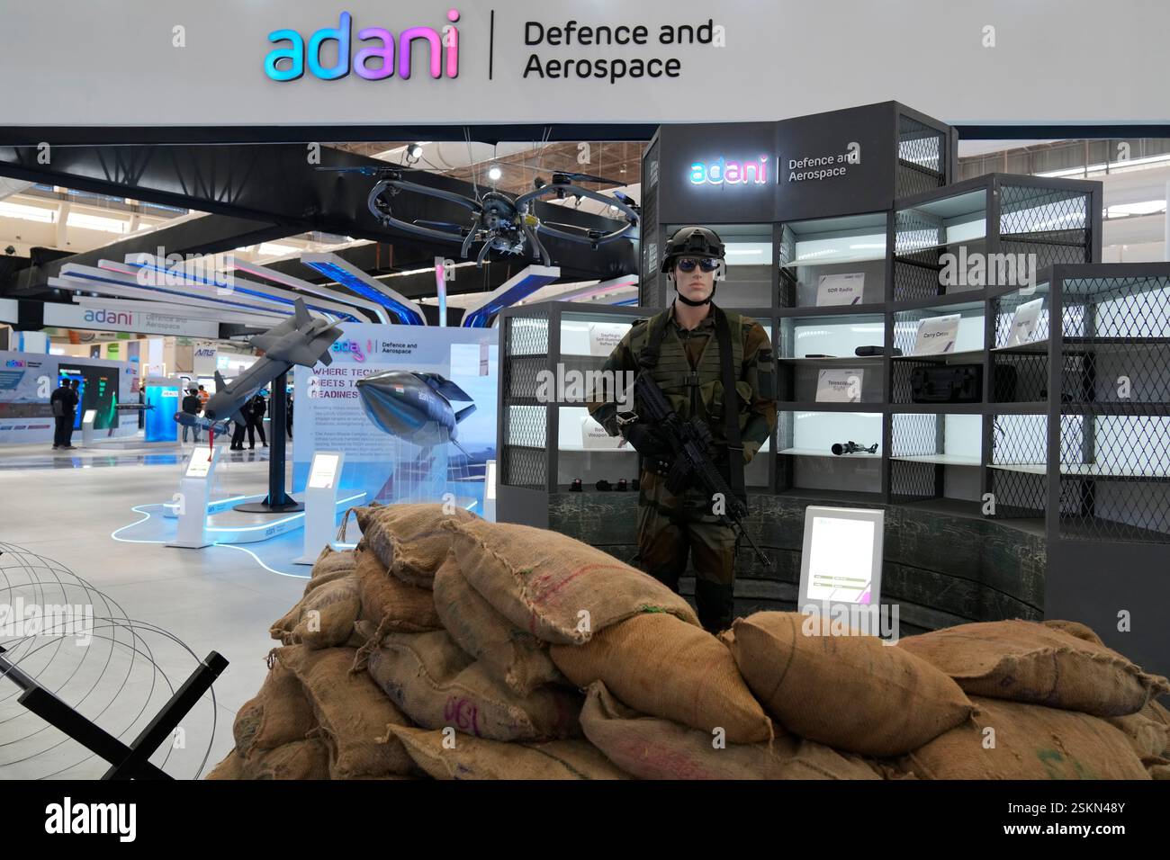Arms and other aerospace equipment are displayed at Adani Defence and ...