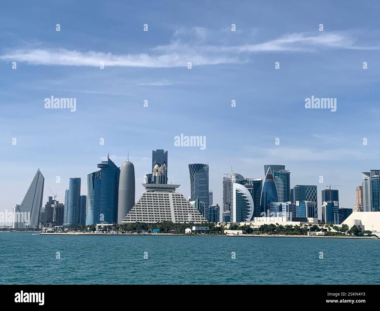Pyramid shaped building amongst skyscrapers of Doha Stock Photo - Alamy