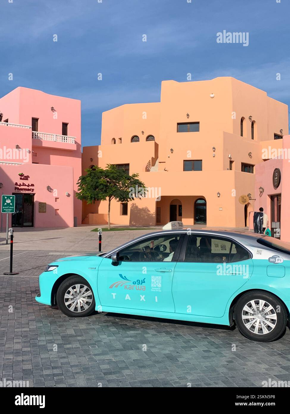 turquoise car with Pastel colour clay buildings in Doha Old Port Stock ...