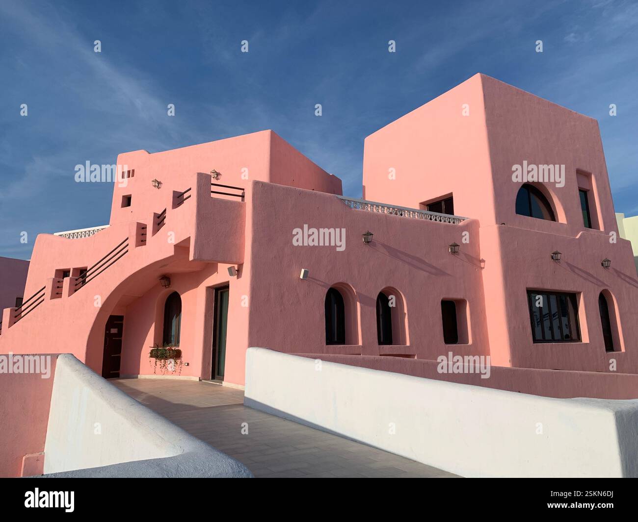 Pastel colour pink clay building at Doha Old Port Stock Photo - Alamy